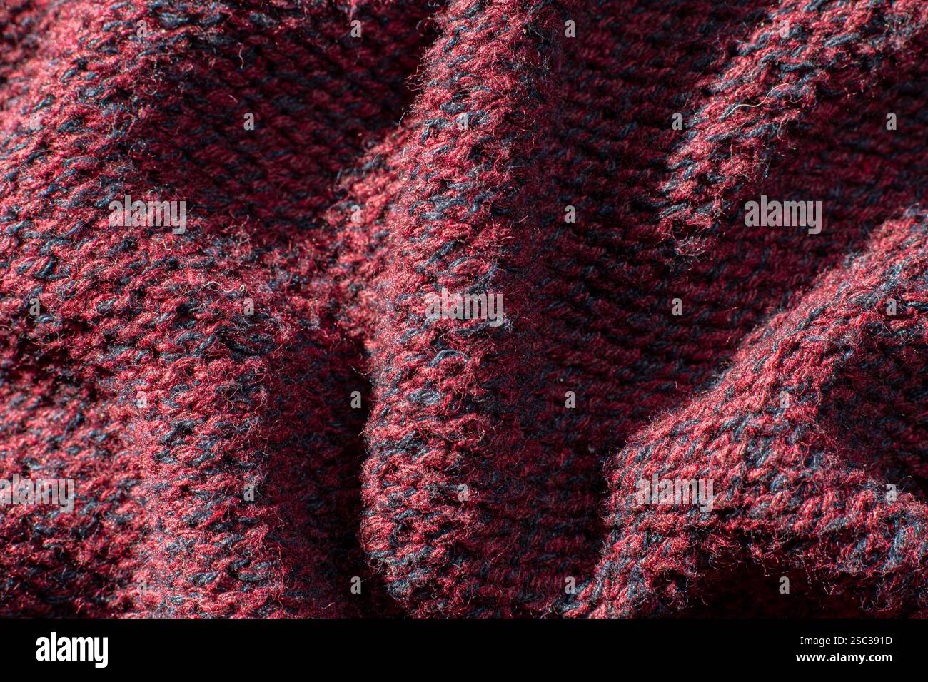 Close-up of the cotton and polyester fabric of a wrinkled red jersey ...
