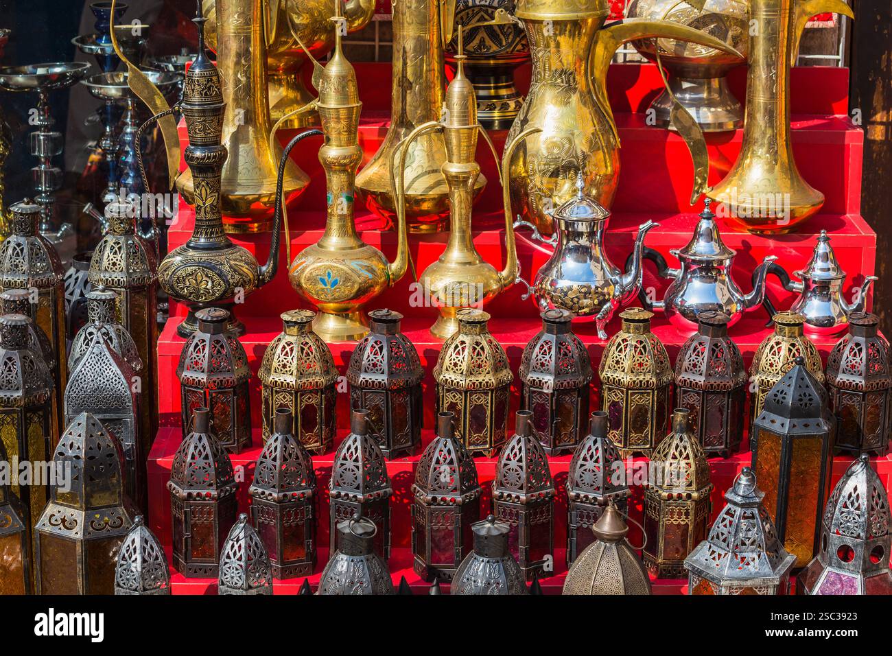 row of shiny traditional coffee pots and lamp at the souq in Dubai ...