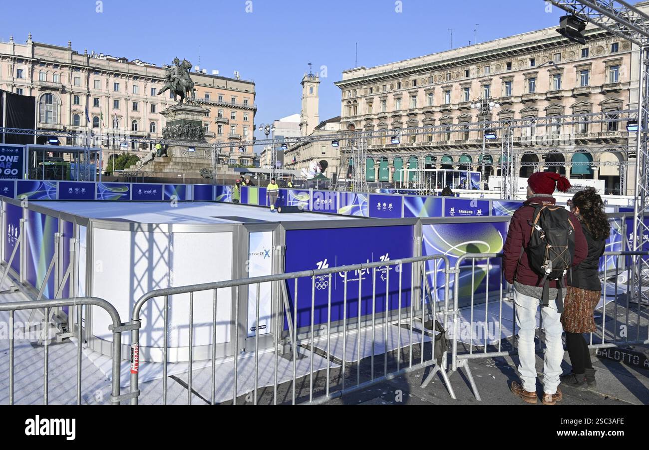A skating rink set up in front of Milan Cathedral is framed by walls ...