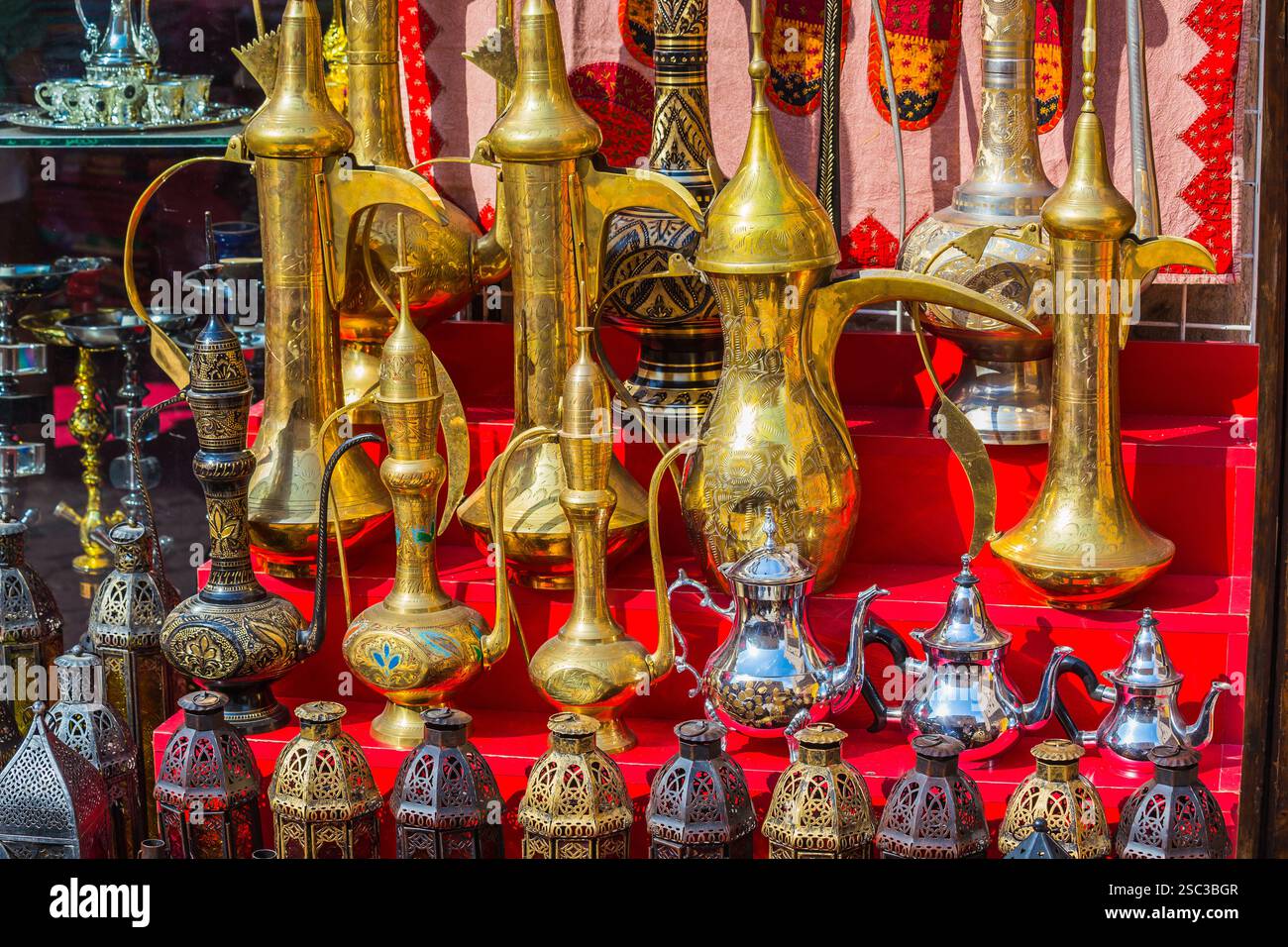 row of shiny traditional coffee pots and lamp at the souq in Dubai ...