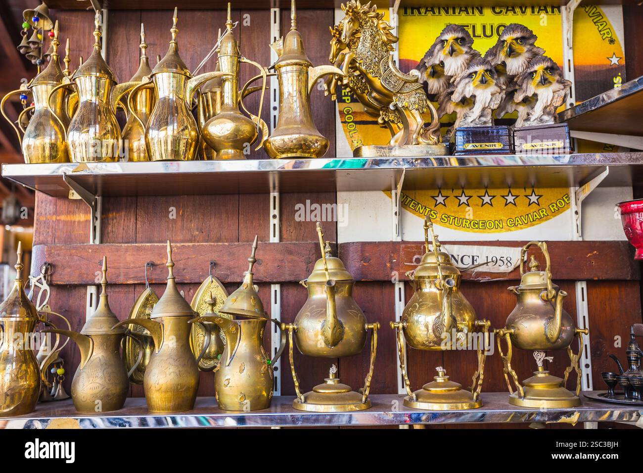 row of shiny traditional coffee pots and lamp at the souq in Dubai ...