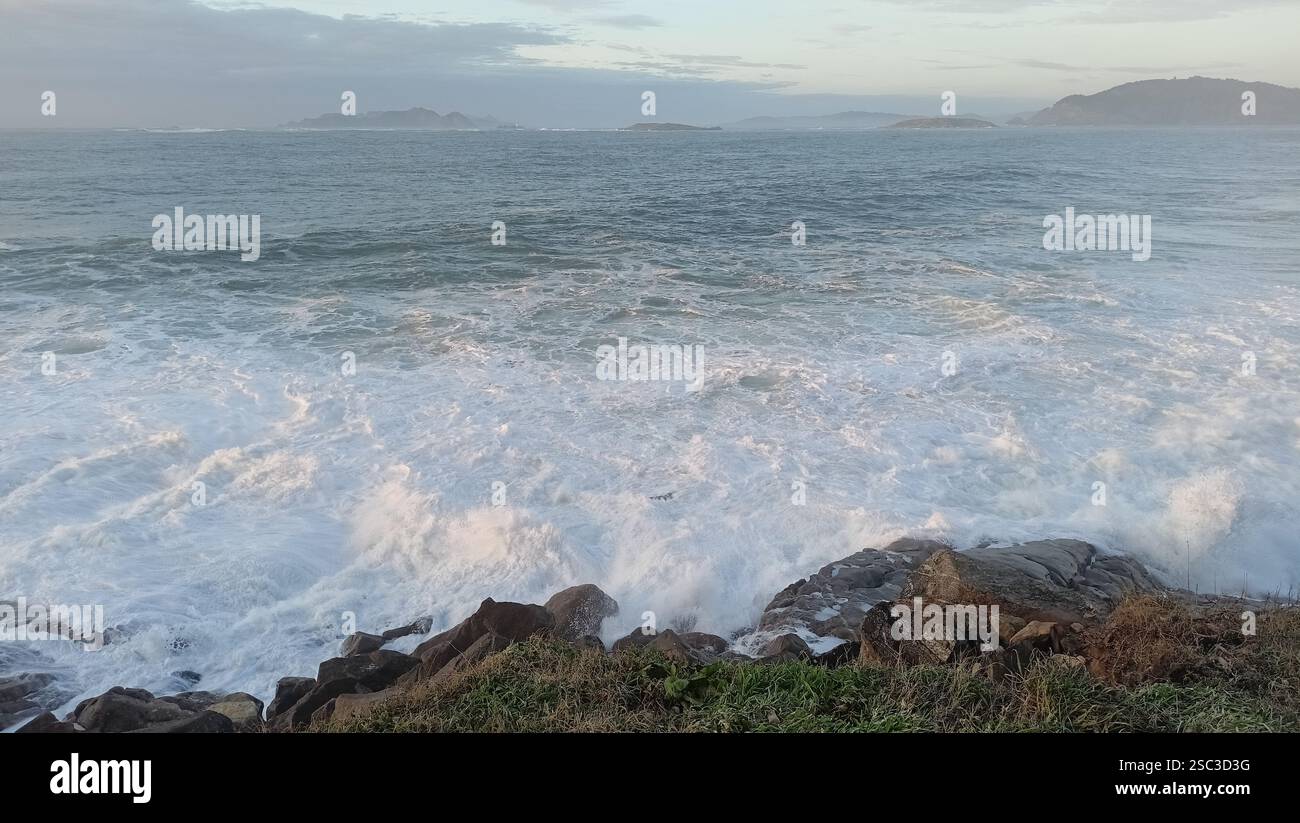 Stunning coastal scene featuring powerful ocean waves crashing against ...