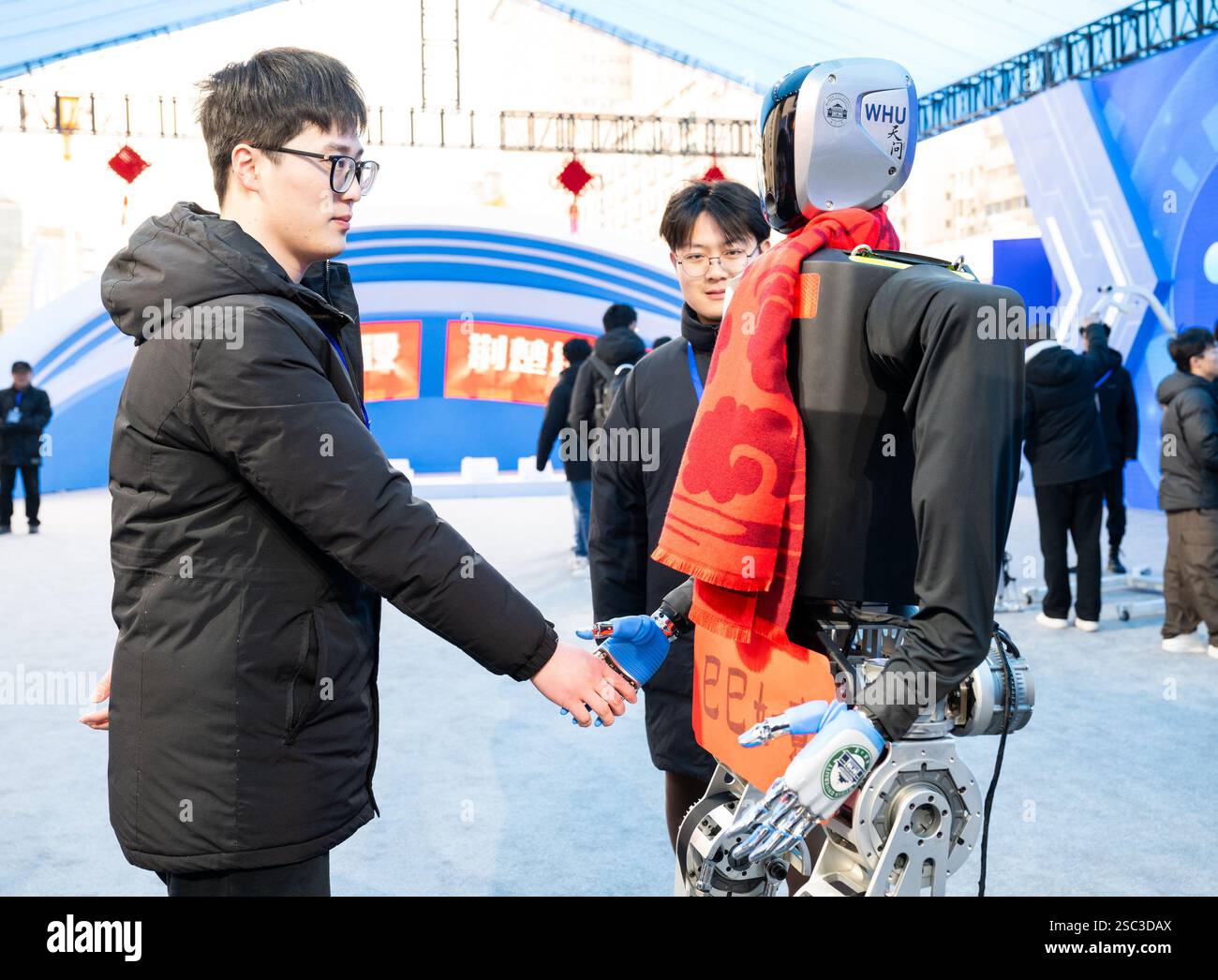 Wuhan, China's Hubei Province. 5th Feb, 2025. A visitor shakes hands ...