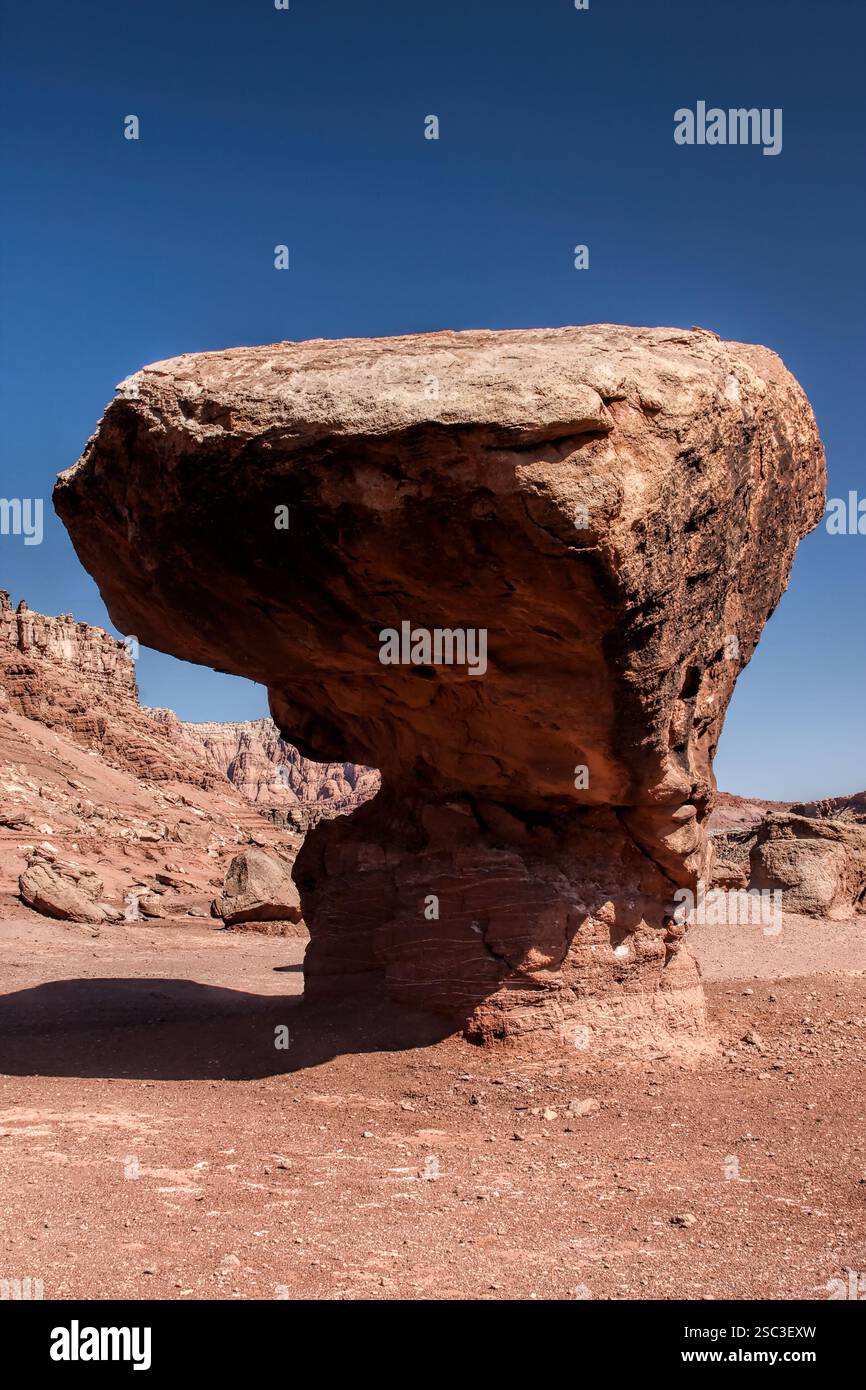 A large rock in the desert. The rock is brown and has a unique shape ...