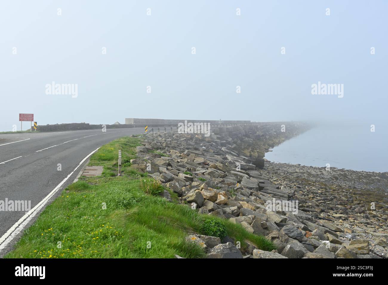 Churchill Barrier causeway on Orkney, disappearing into the fog Stock ...