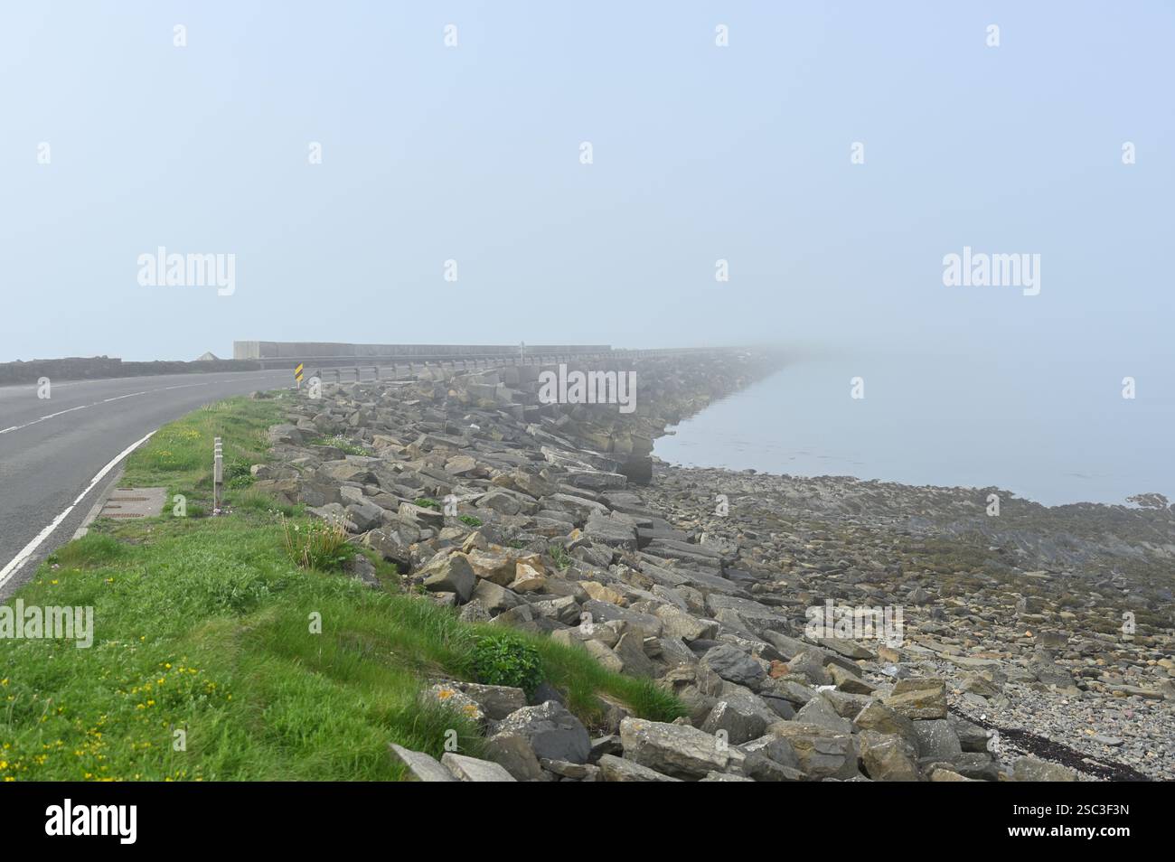Churchill Barrier causeway on Orkney, disappearing into the fog Stock ...