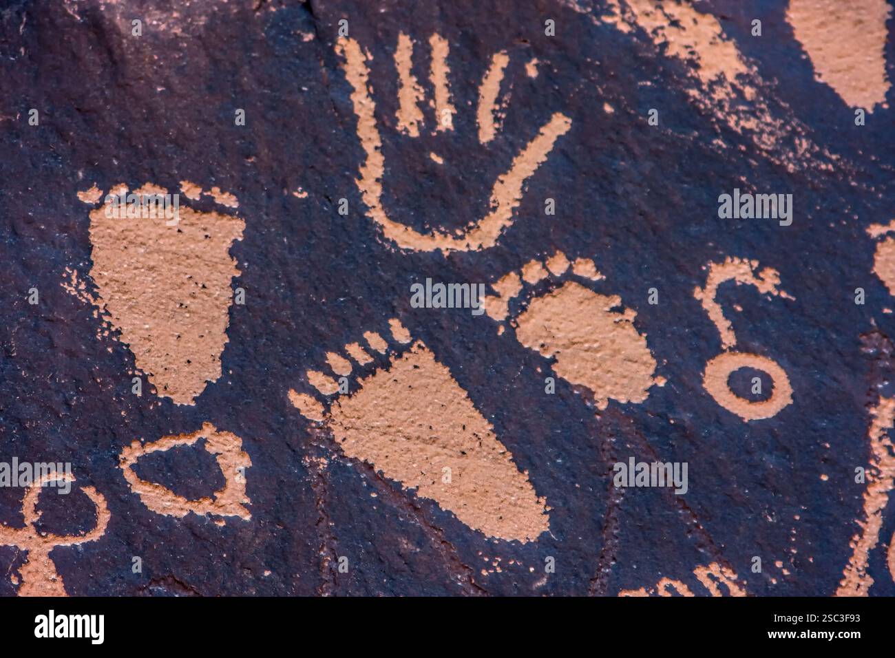 A rock with hand prints on it. There are four feet and two hands Stock ...