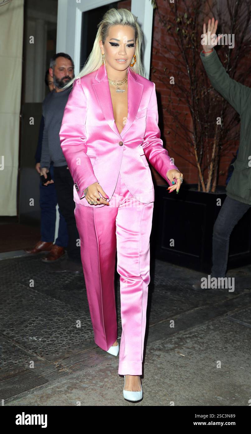 Singer Rita Ora greets fans as she leaves a downtown hotel on January ...
