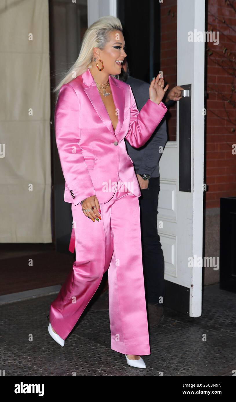 Singer Rita Ora greets fans as she leaves a downtown hotel on January ...