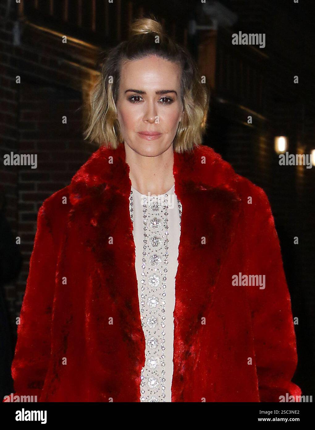Actress Sarah Paulson bundled up in a red fur coat as she made an ...