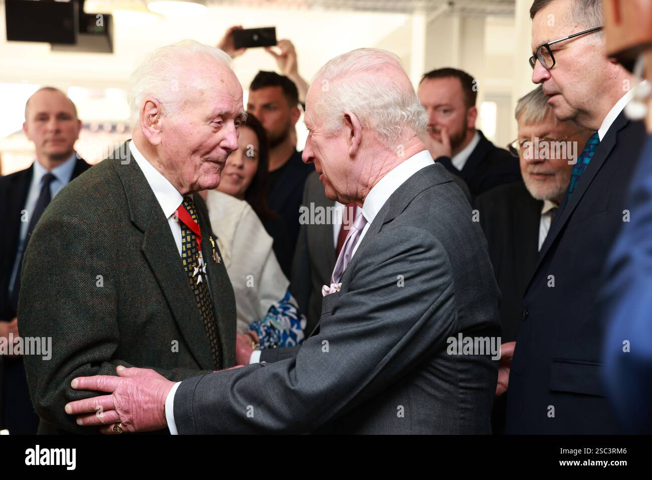 King Charles III meeting D-Day veteran Eugeniusz Niedzielski during a ...