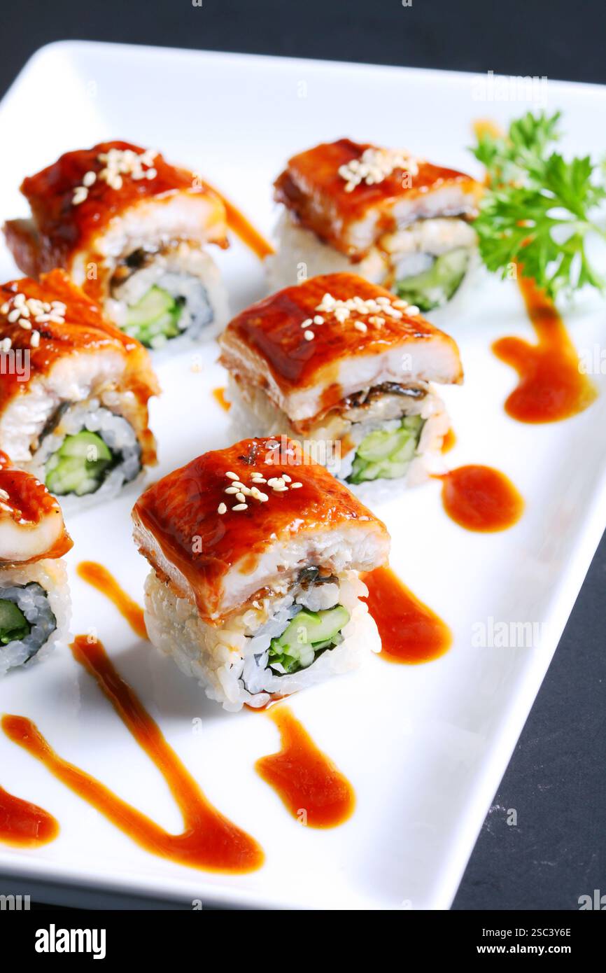 Unagi Maki Roll on white plate background Sushi roll with Grilled eel and Cucumber, Asparagus ...