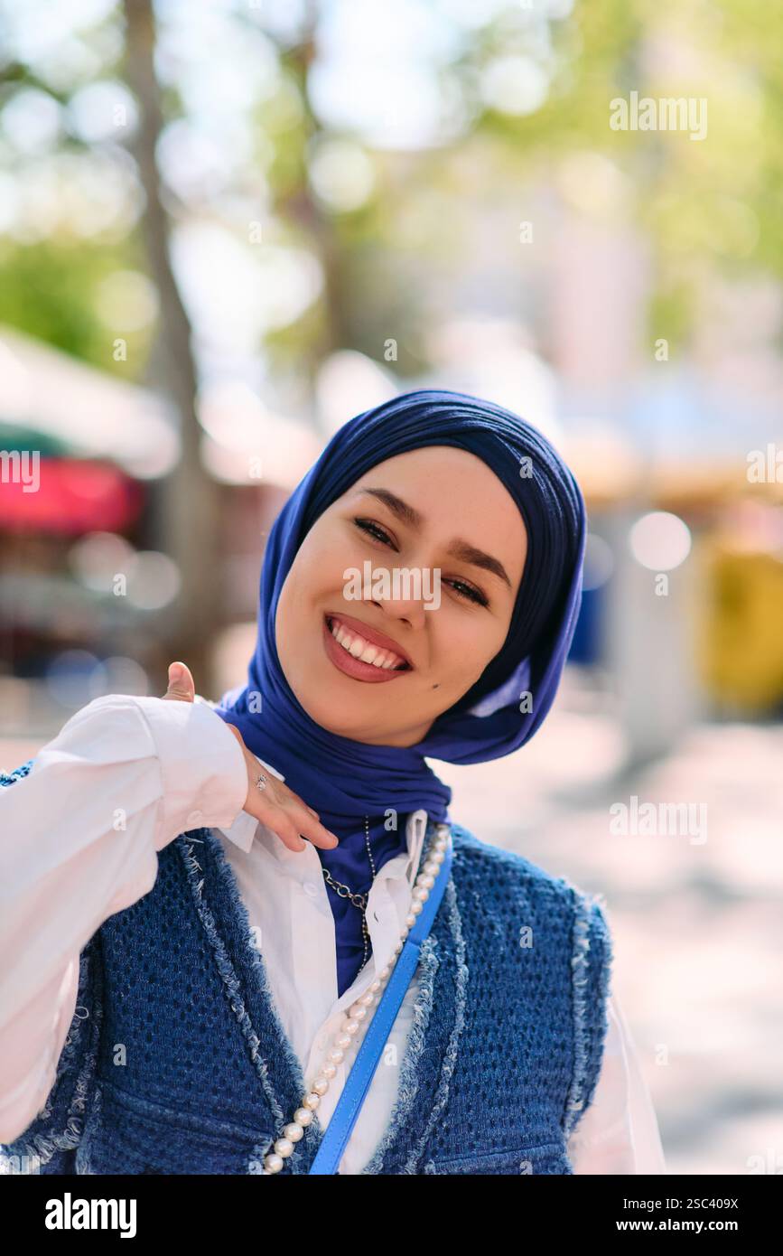 Radiant Beauty: A Woman in Hijab Embracing the Sunshine Stock Photo - Alamy