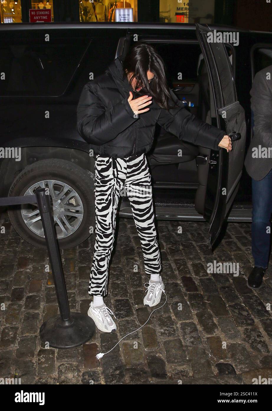 Model Kendall Jenner struggles with a charging cable as she makes a ...