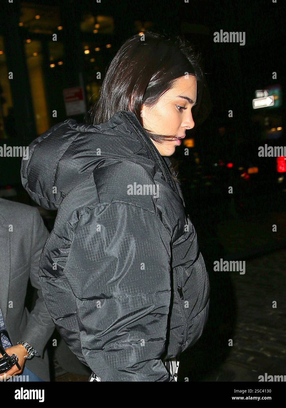 Model Kendall Jenner struggles with a charging cable as she makes a ...