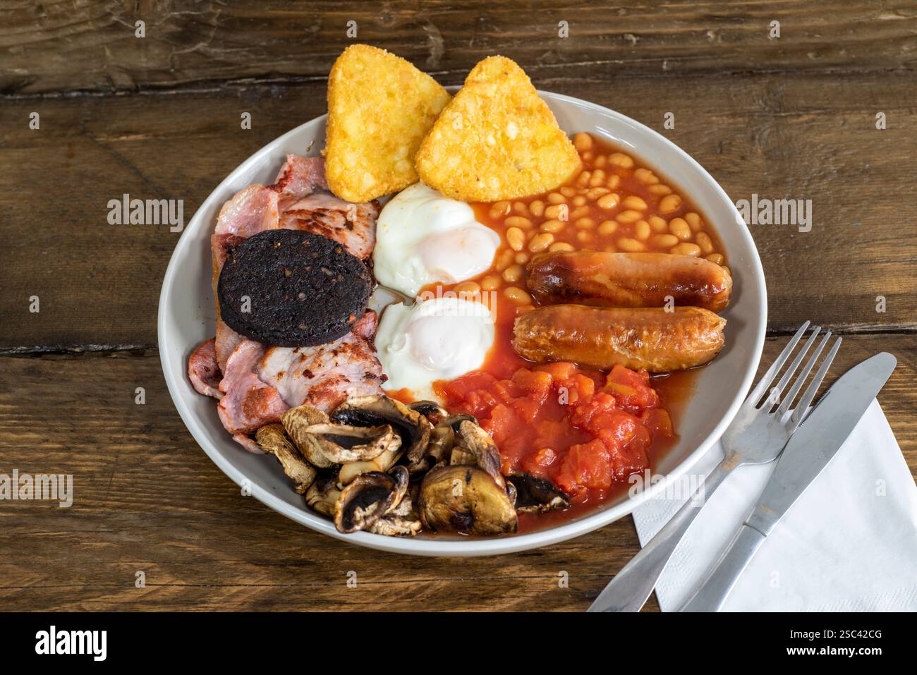 Full English Breakfast with sausages, bacon, eggs, black pudding, baked ...