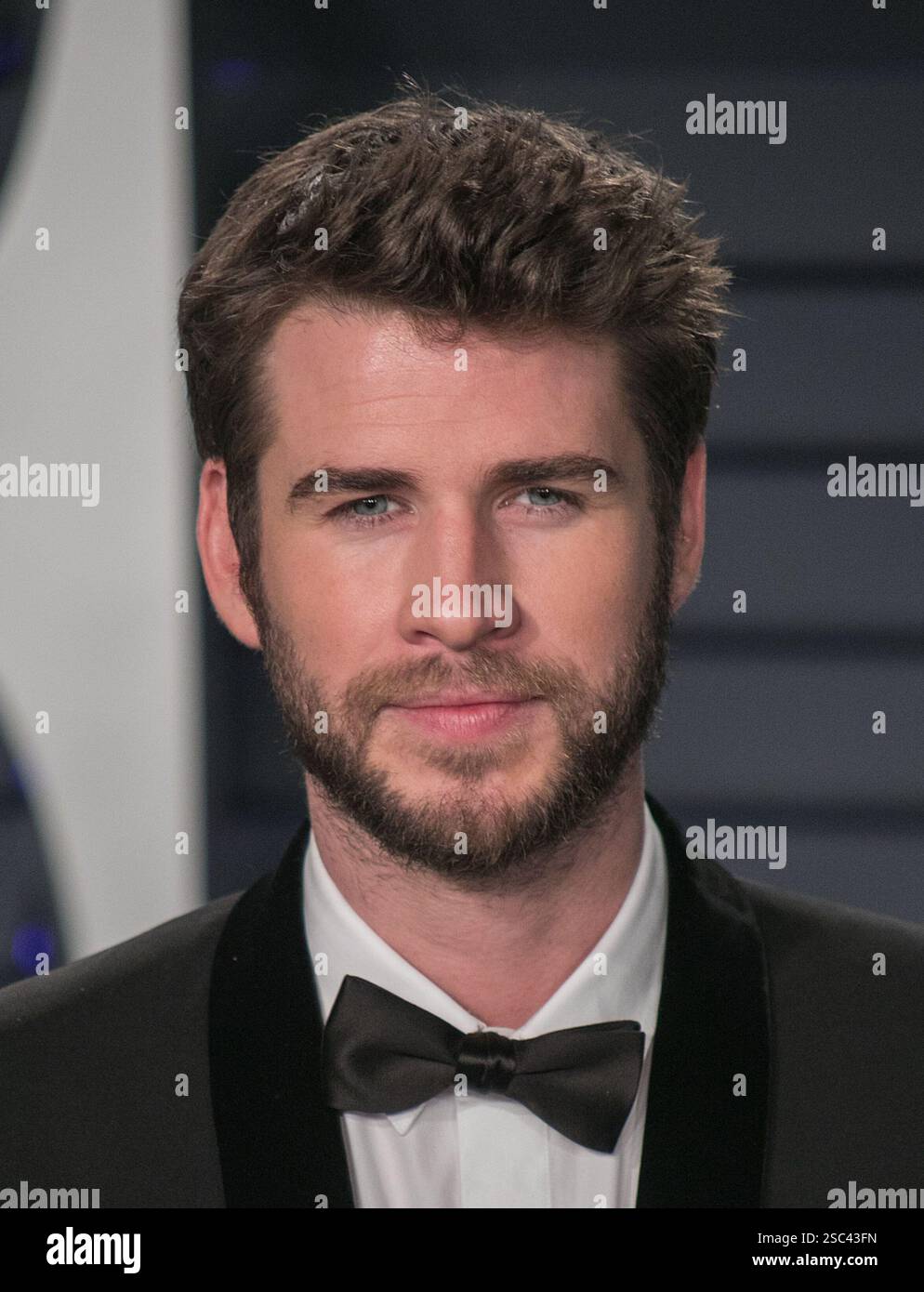 Liam Hemsworth arriving at the 2019 Vanity Fair Oscar Party at the ...