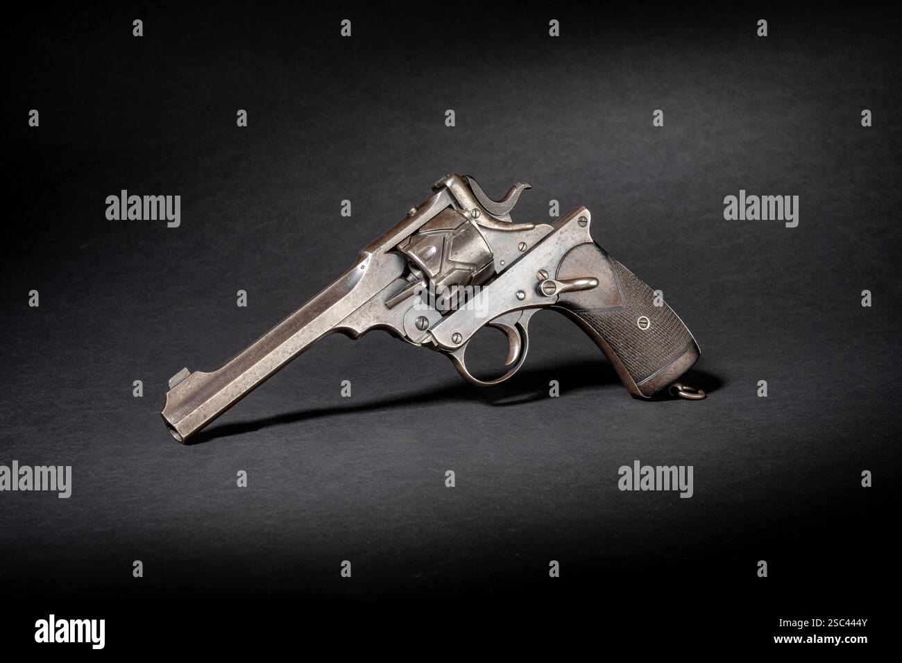 Studio shot of an old revolver firearm on black background with drop ...
