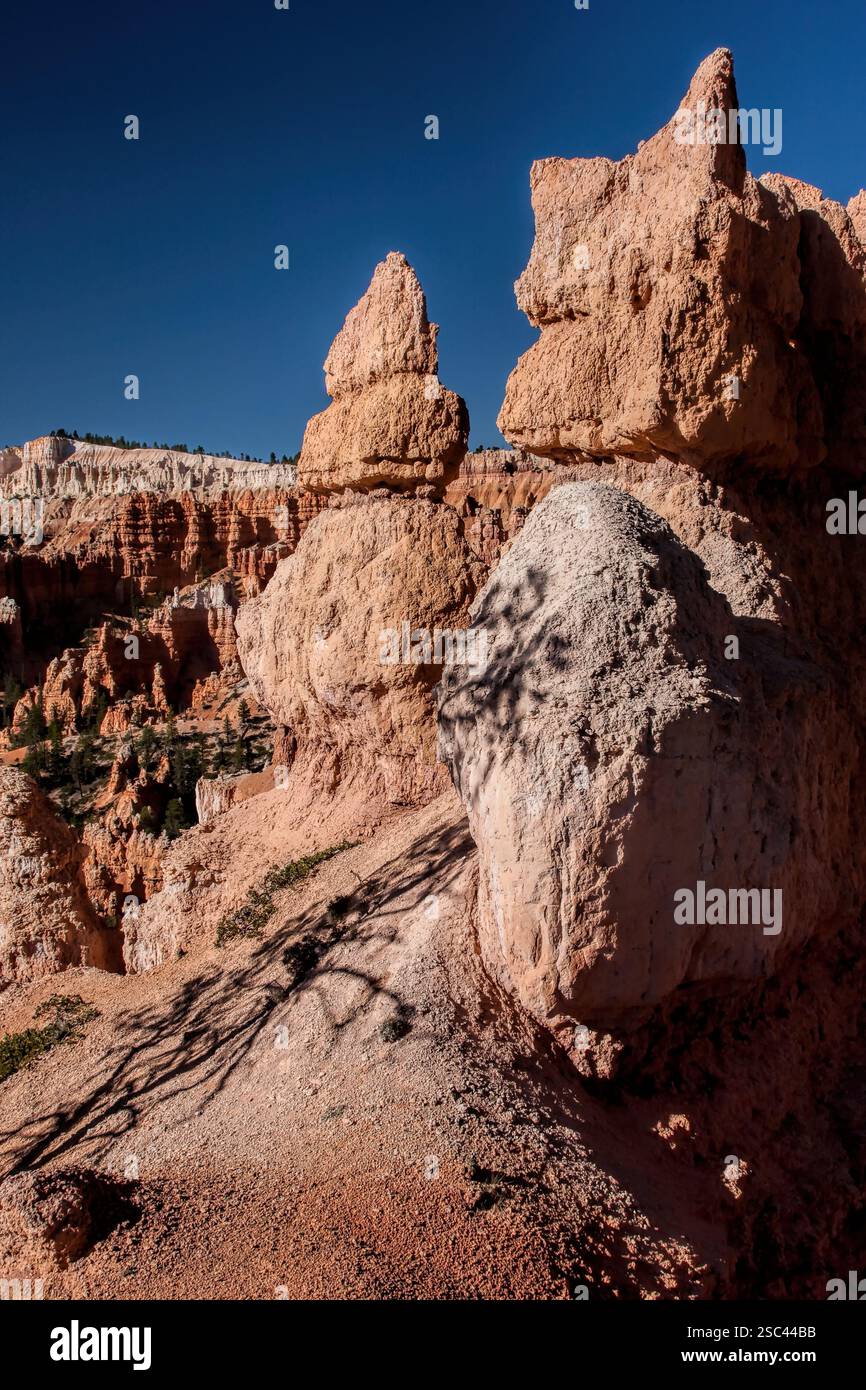A large rock formation with a shadow cast on it. The shadow is on the ...