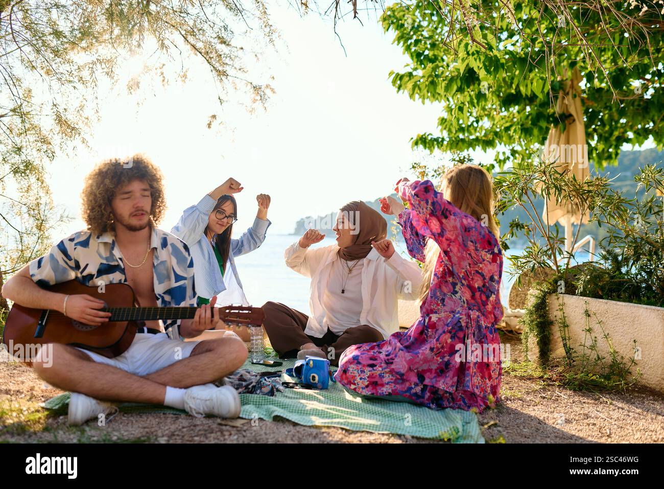 A group of friends gather on the beach sharing joyful moments filled ...