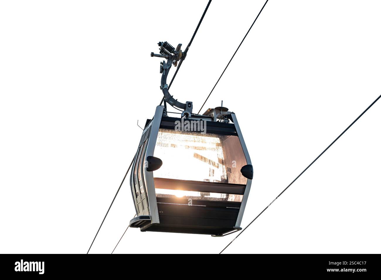 The cable car is suspended in the air. The cable car has a large window ...
