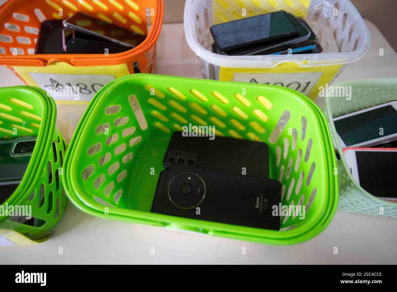 Student's cell phones sit in baskets after they were turned in at the ...