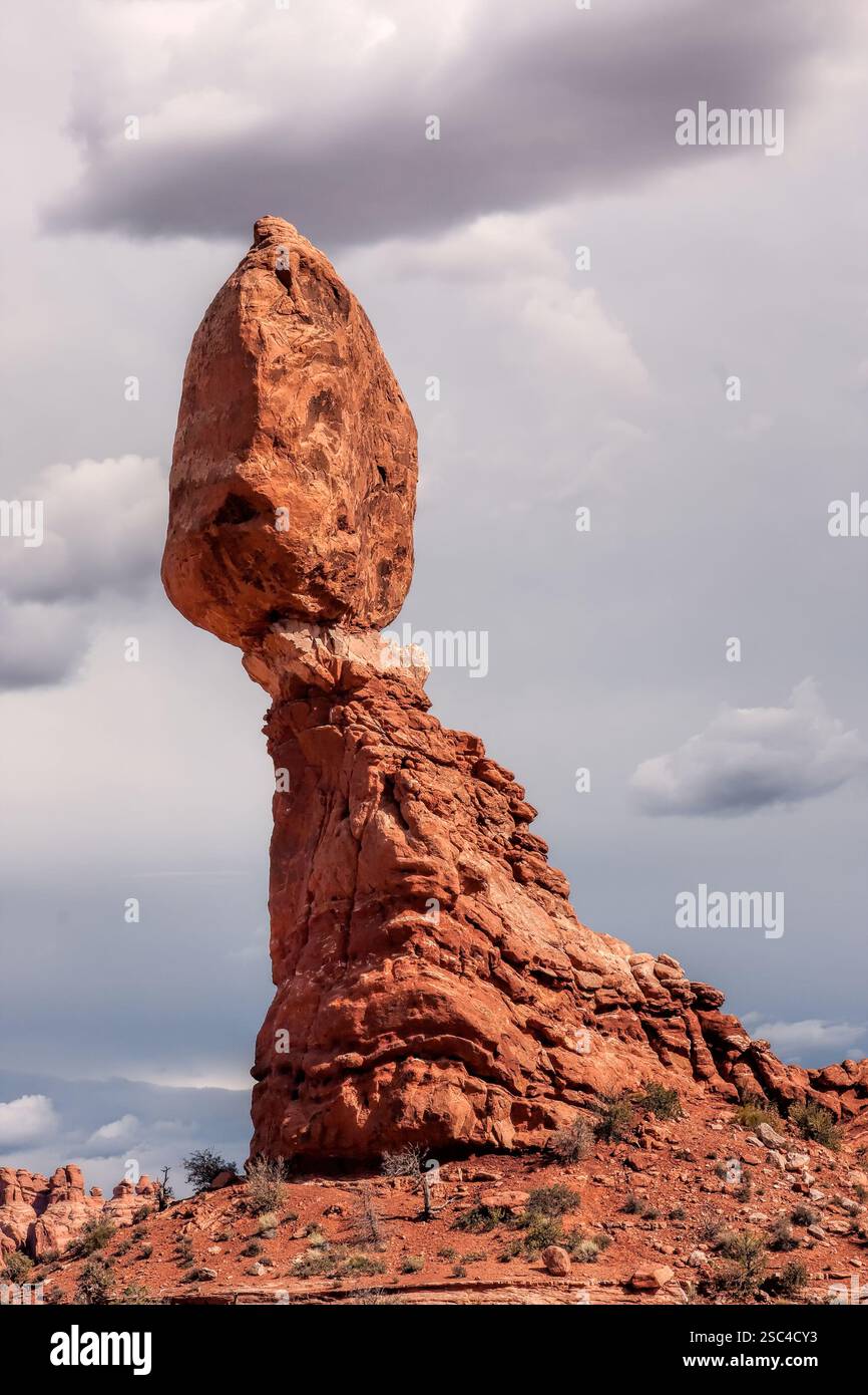 A rock formation that looks like a pyramid. It is red in color. The sky ...