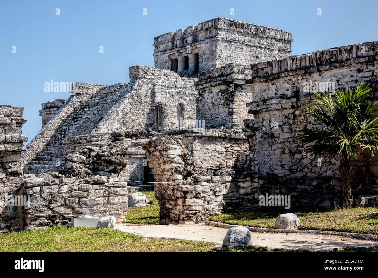A large stone building with a stone archway. The archway is open. There ...