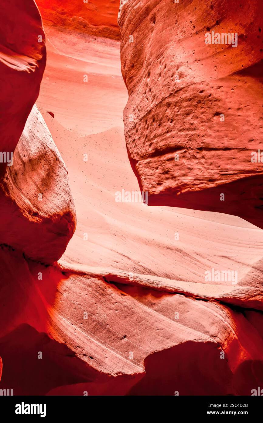 A large, red rock formation with a hole in the middle. The hole is ...