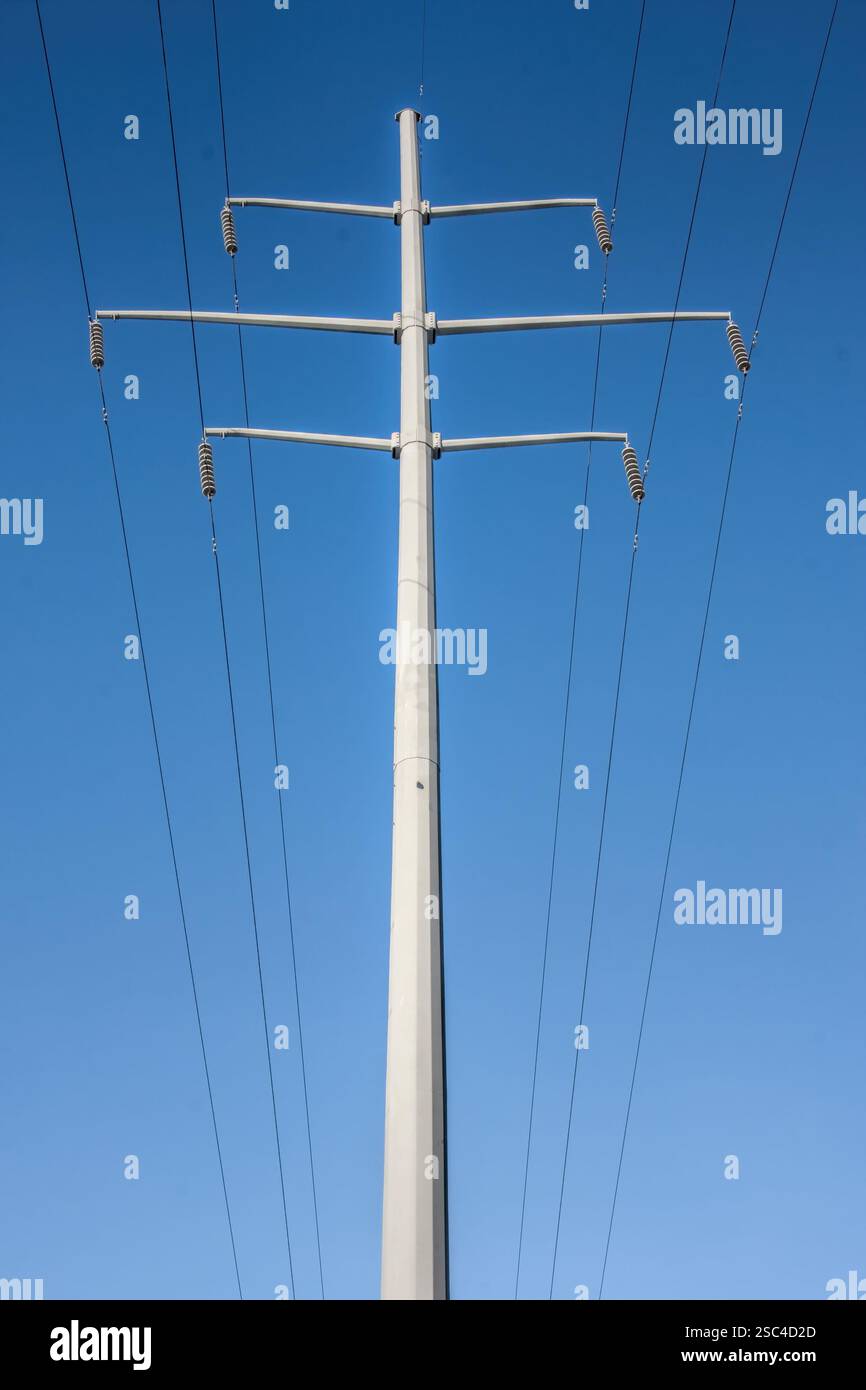 A tall power pole with many wires on it. The pole is in the middle of a ...