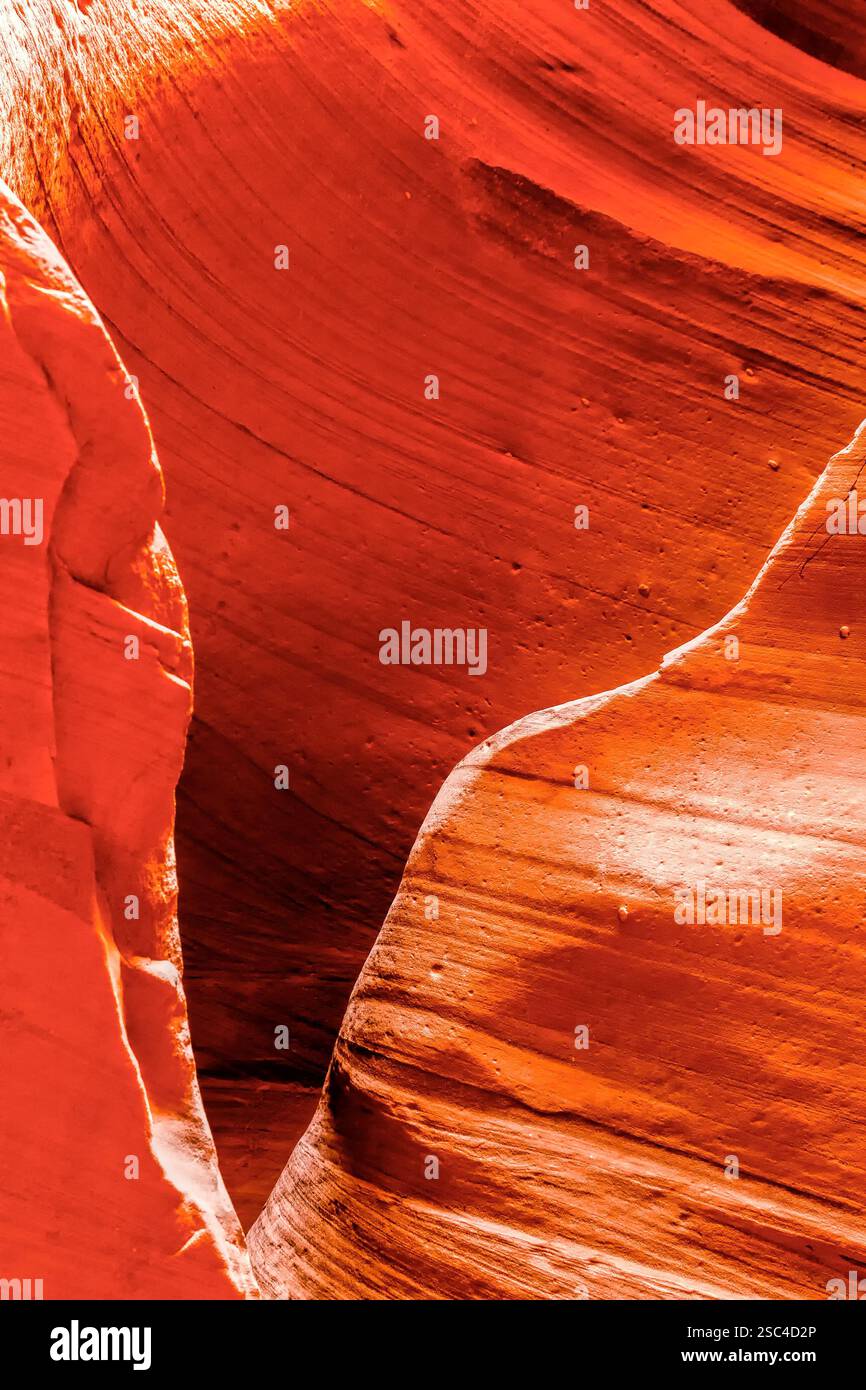 A red rock formation with a brownish color. The rock is very rough and ...