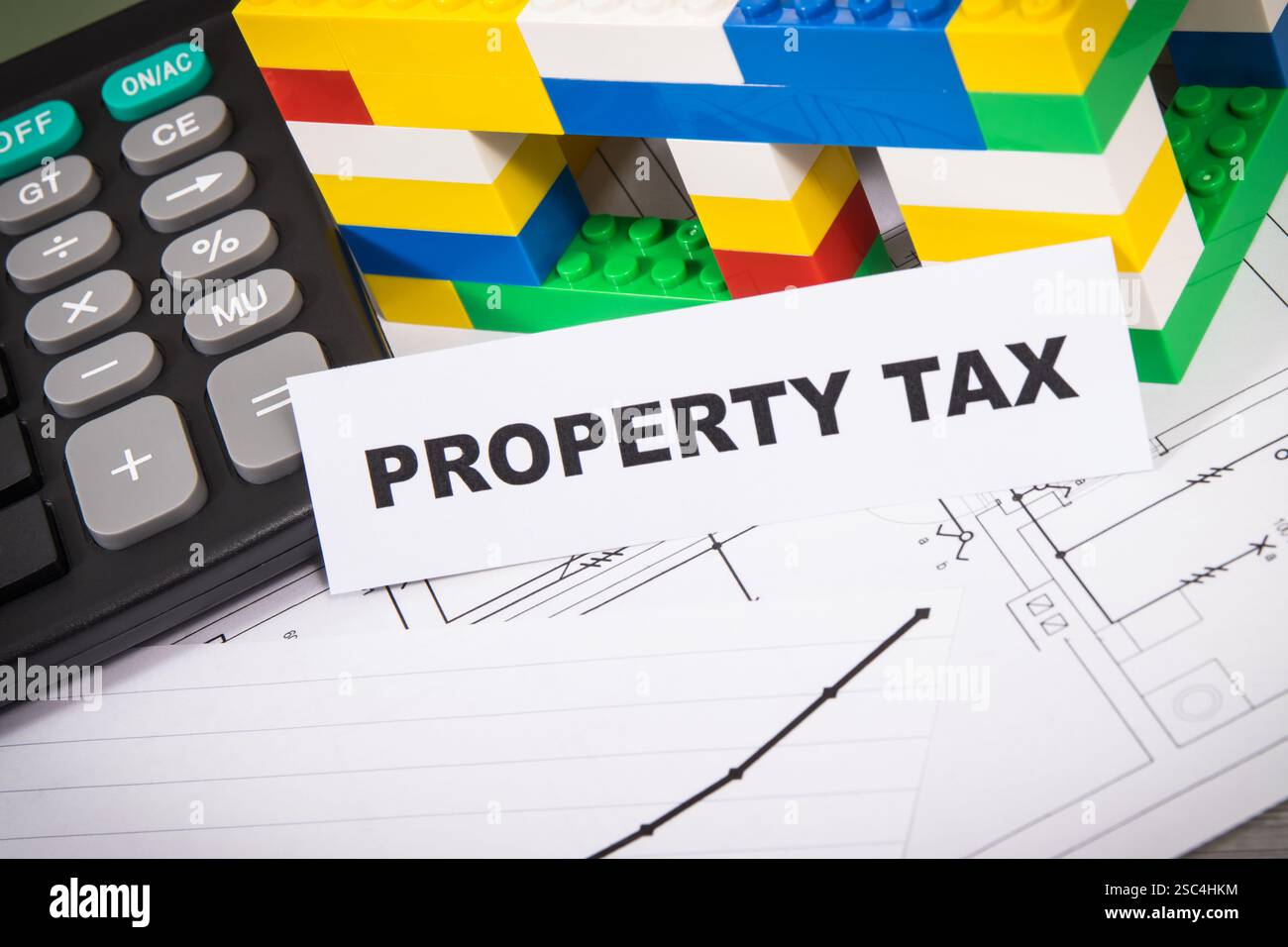 Inscription property tax, calculator, small house made of colorful toy ...