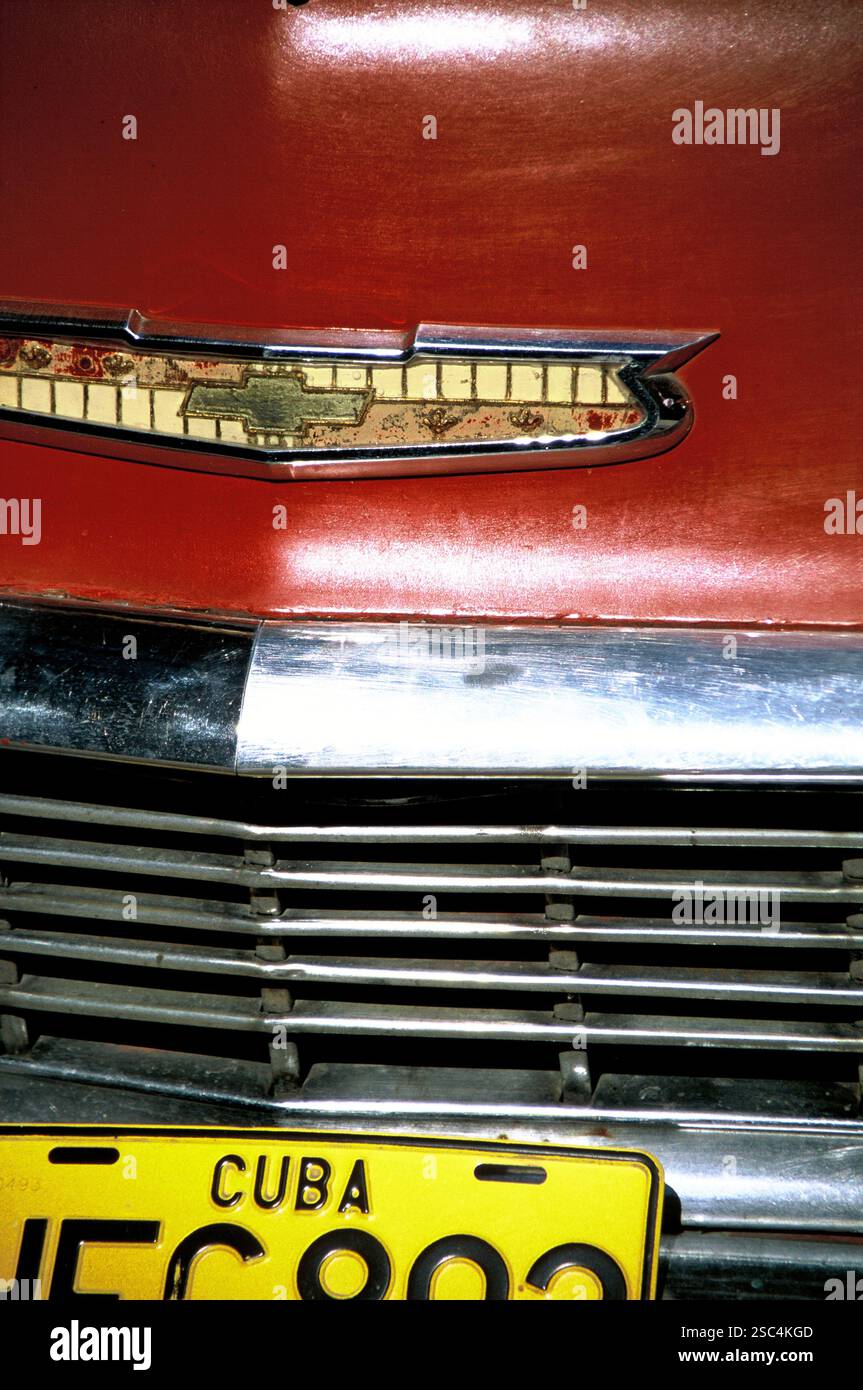A striking vintage red car showcases its distinctive chrome grille and ...