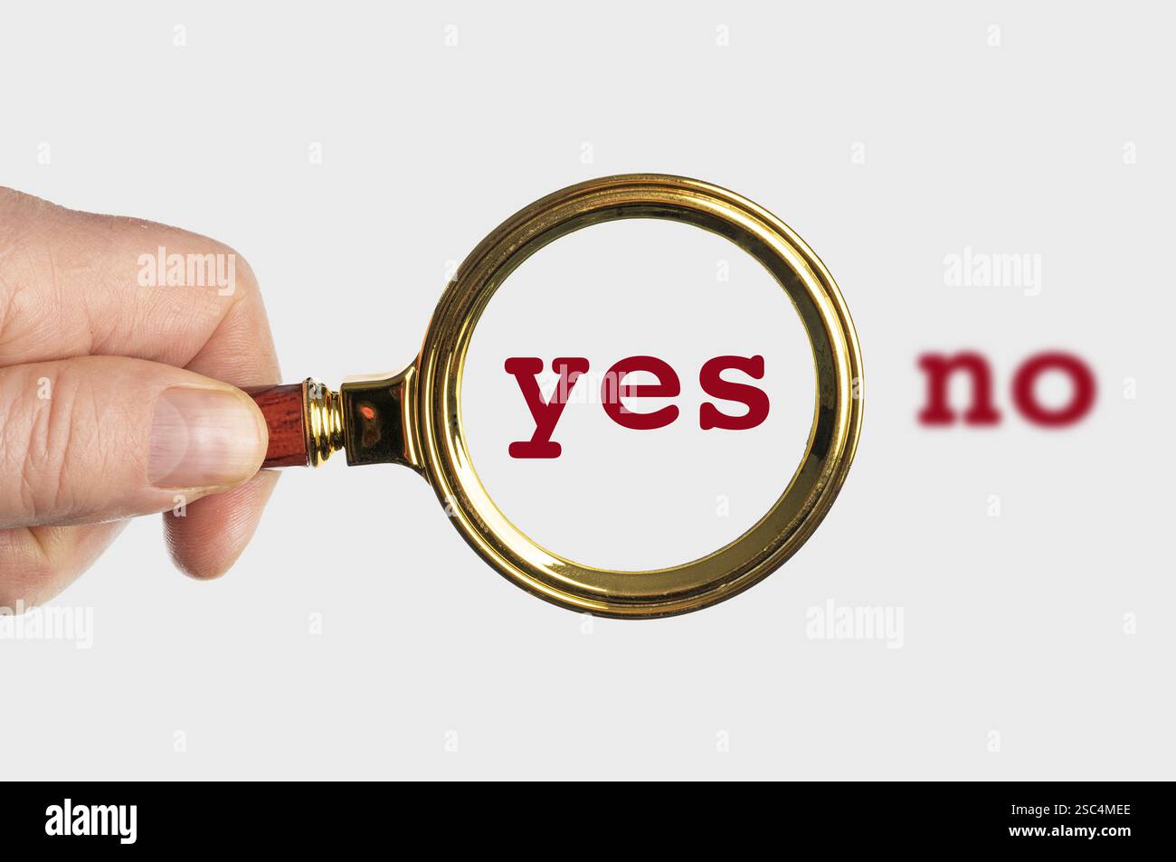the focus on Yes word through a Magnifying glass Stock Photo - Alamy