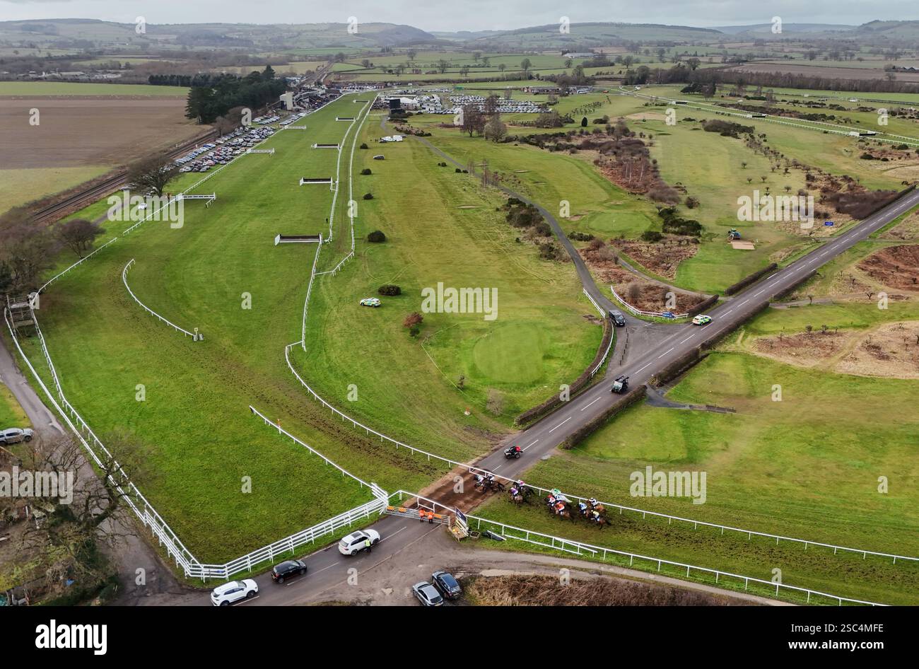 Traffic is stopped as runners and riders cross the road during the Mick ...