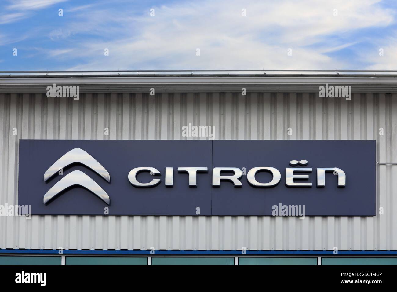 Citroen logo at the dealership with blue sky and clouds. The French ...