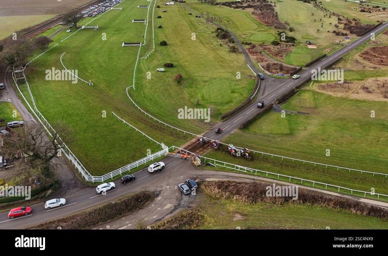 Traffic is stopped as runners and riders cross the road during the Mick ...
