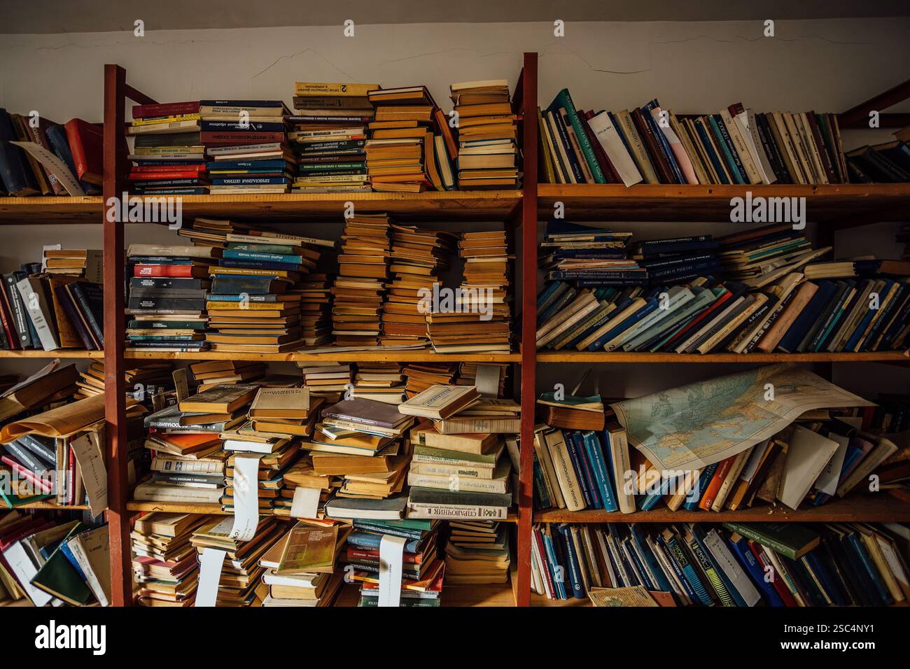 Old books on shelves in cabinet of abandoned library Stock Photo - Alamy