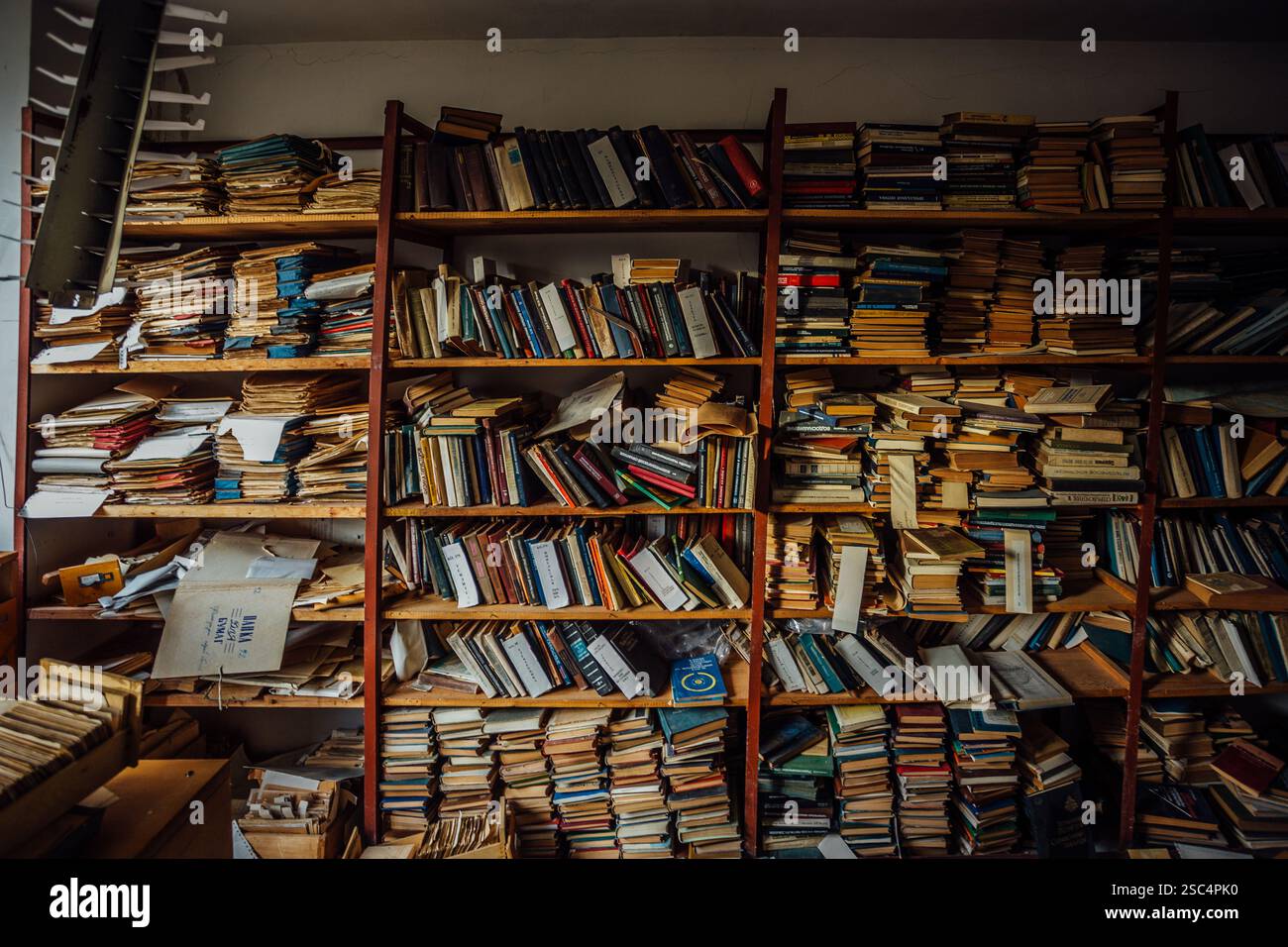 Old books on shelves in cabinet of abandoned library Stock Photo - Alamy
