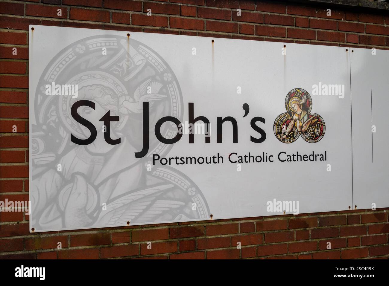 Sign for St John's Portsmouth Catholic Cathedral on a brick wall ...