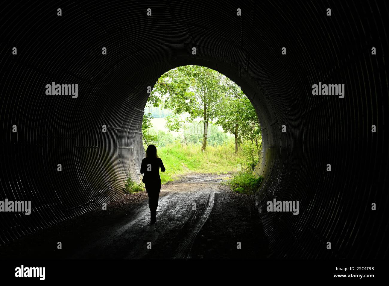 Walking through dark tunnel hi-res stock photography and images - Alamy