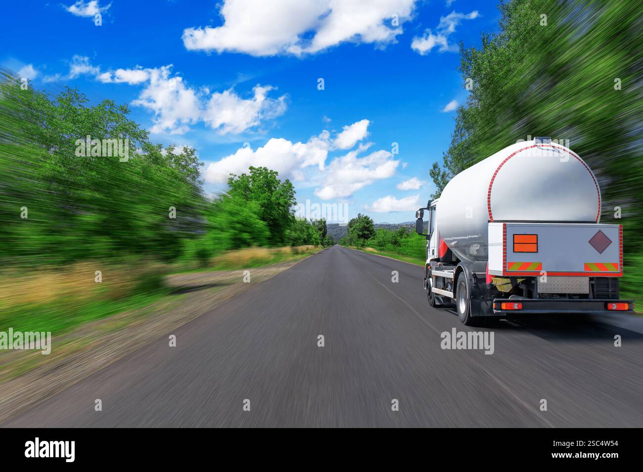 A fuel tanker truck speeds down a rural highway Stock Photo - Alamy