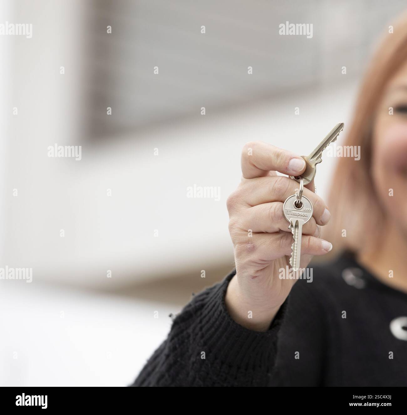 The keys to your new home! Lady holding house keys with blurred ...