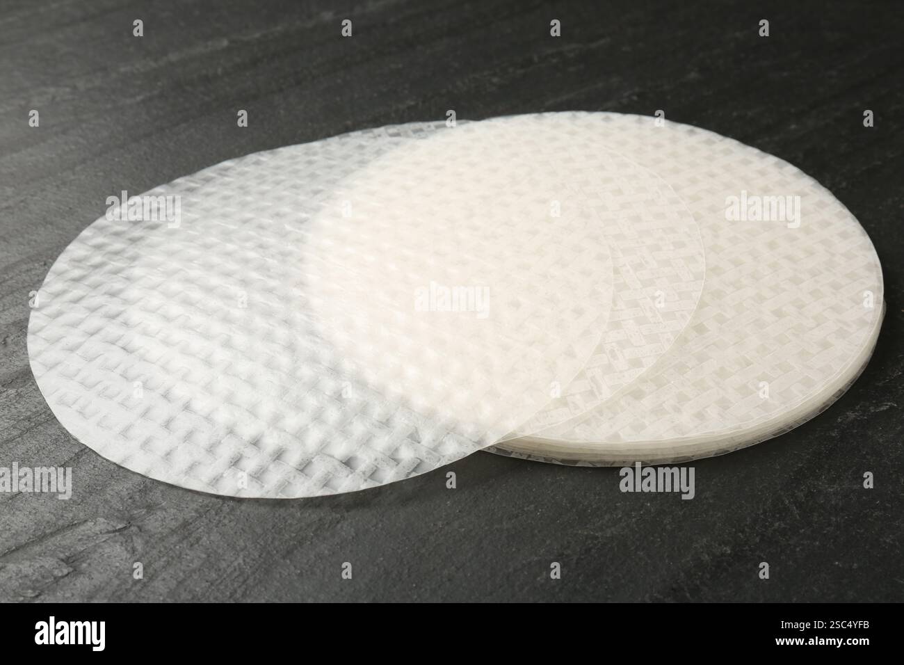 Edible rice paper sheets on dark textured table, closeup Stock Photo ...