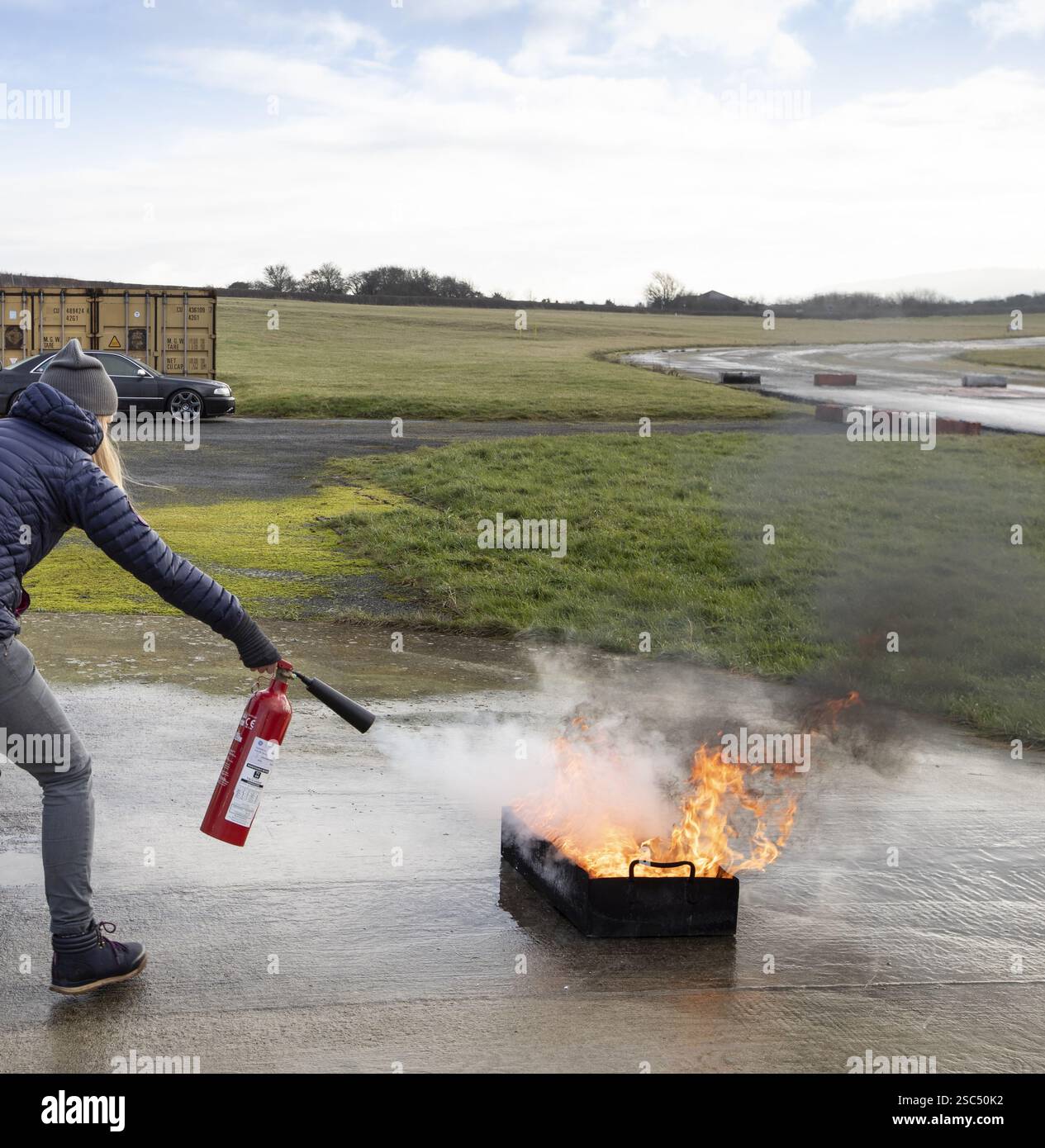 Training staff to use fire extinguishers safely Stock Photo - Alamy