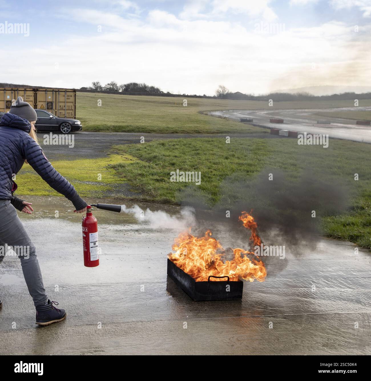 Training staff to use fire extinguishers safely Stock Photo - Alamy