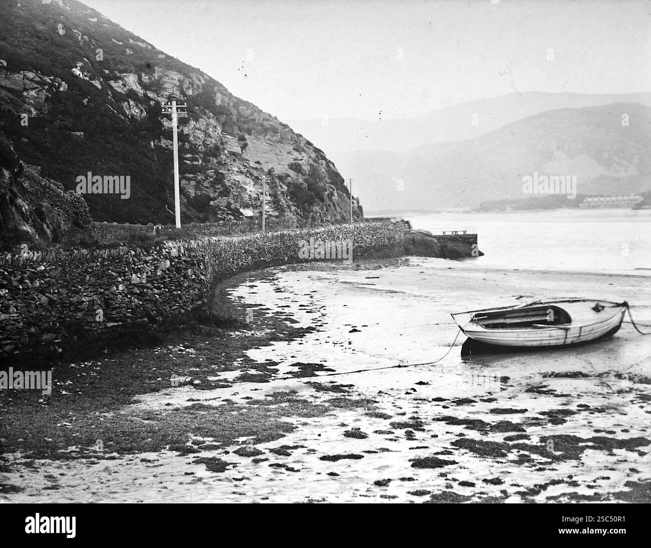 The estuary, Barmouth, Gwynedd, Wales, with a tethered rowing boat on ...