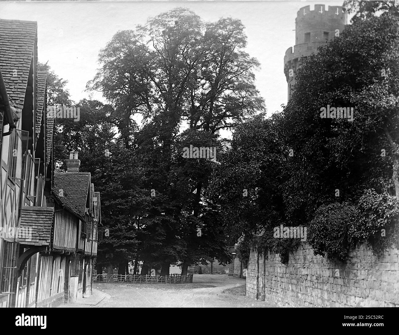 A street with houses and trees opposite the grounds of Warwick Castle ...