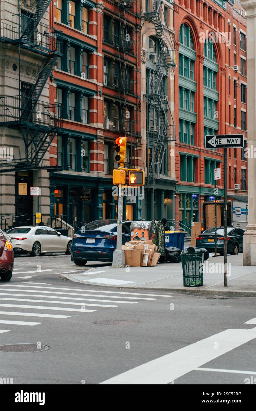 A bustling city intersection features traffic lights guiding vehicles ...