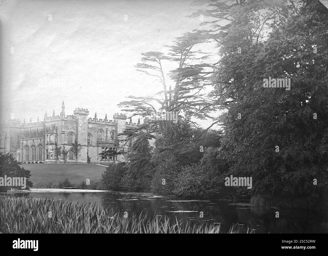 A view of Arbury Hall and the lake from the grounds, an Elizabethan ...